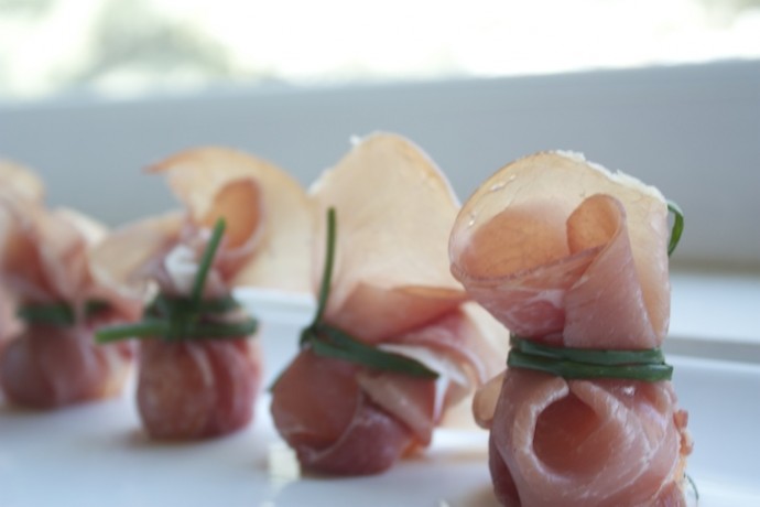 Prosciutto Wrapped Melon all tied with a Chive.